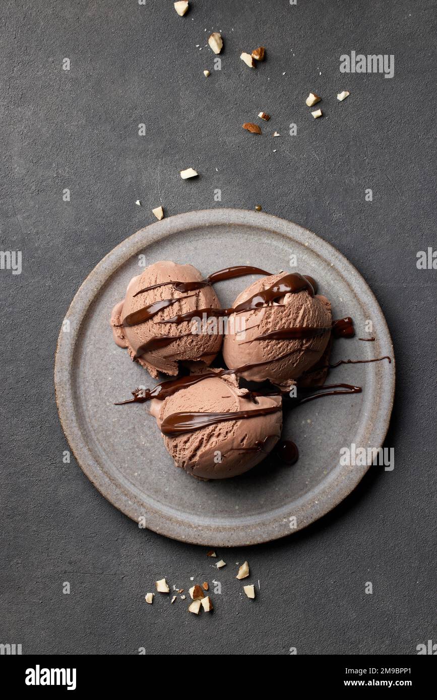 chocolate ice cream portion decorated with melted chocolate and almonds ...
