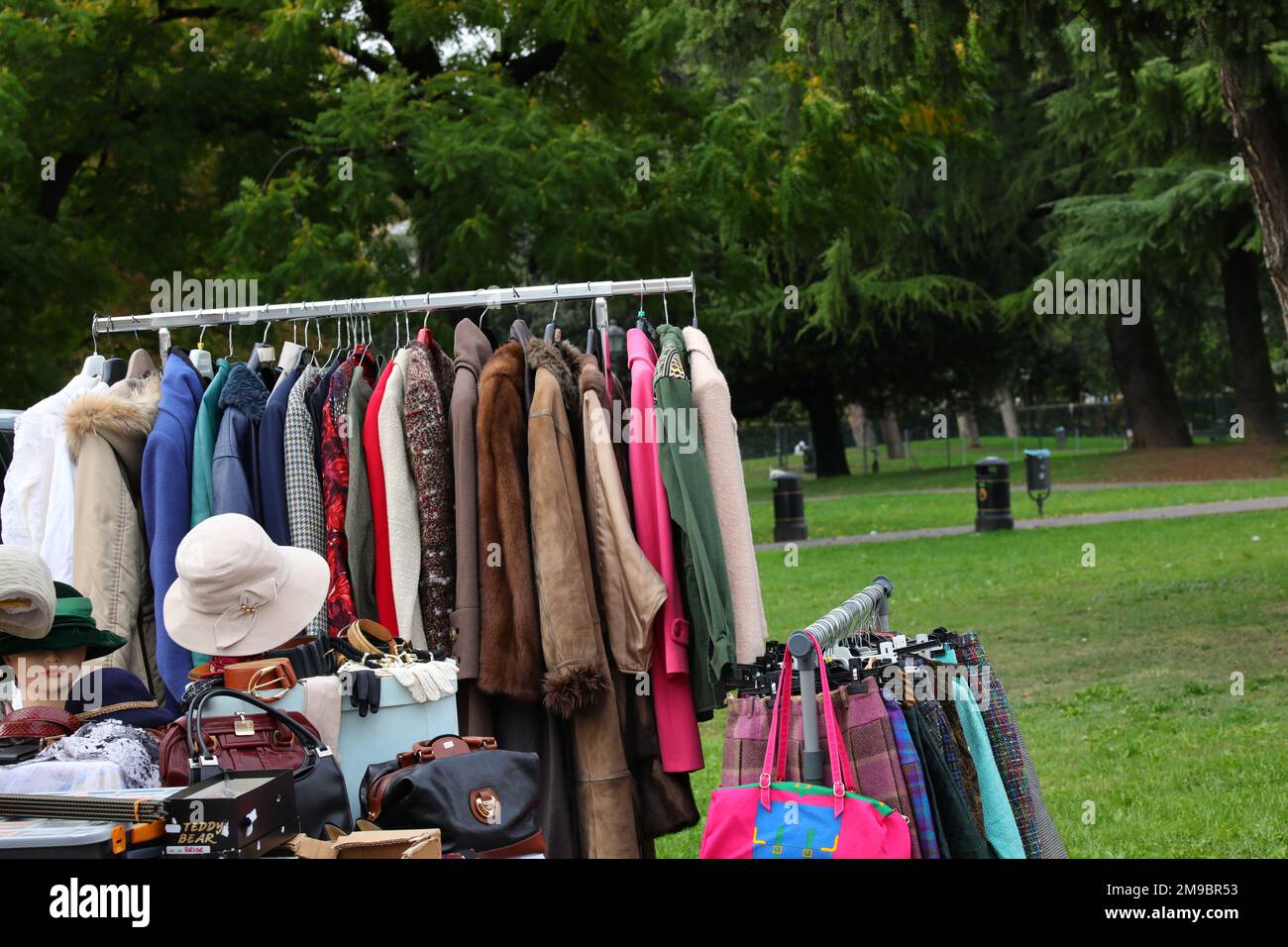 vintage used clothes and new dresses in the stall at the flea market ...