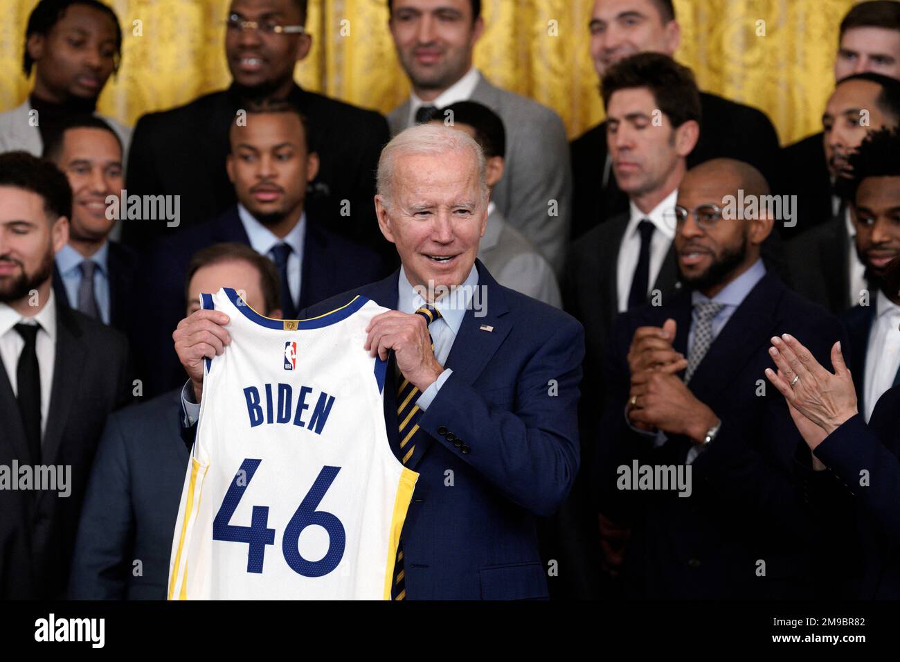 U.S. President Joe Biden is presented a jersey as he welcomes the ...