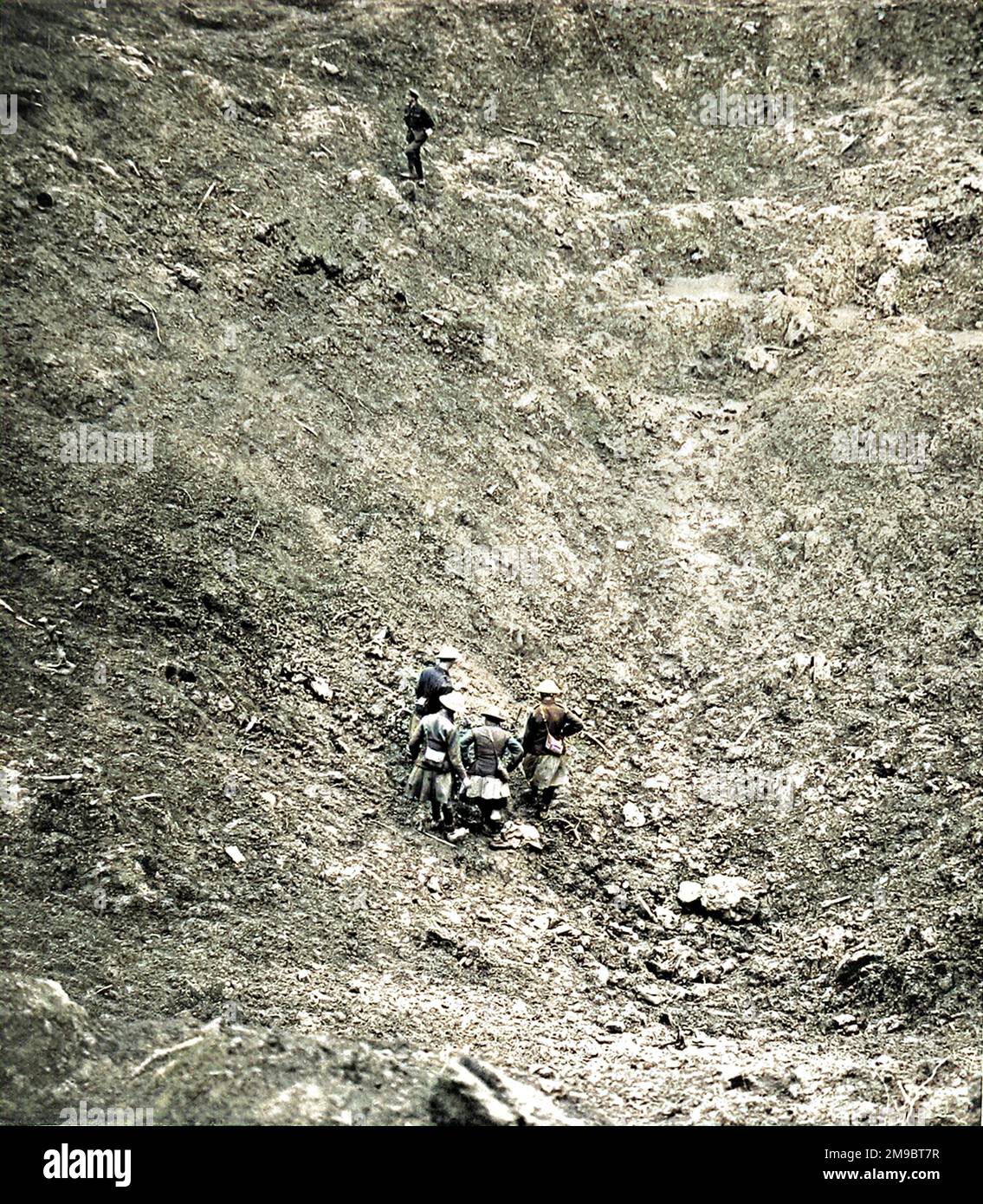 Several British soldiers walking through the enormous crater left ...