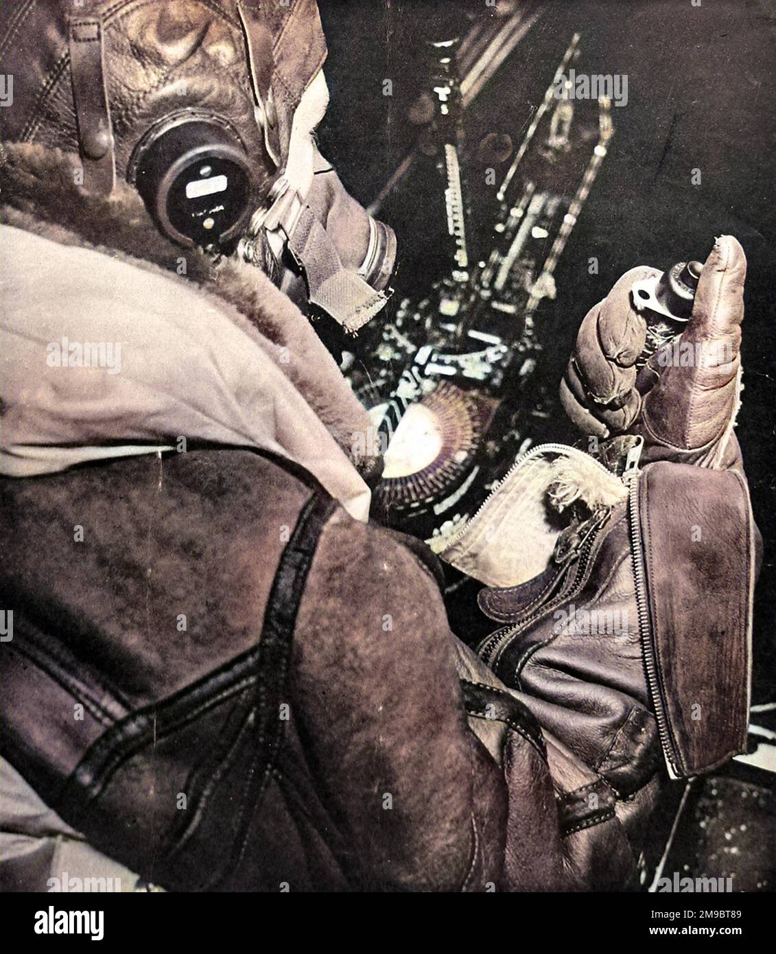 Photograph showing a Royal Air Force bomb-aimer at his position with ...