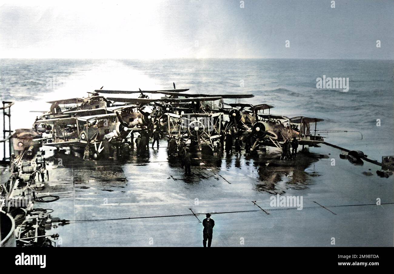 Fleet Air Arm 'Swordfish' torpedo-bombers gathered on the stern of the ...