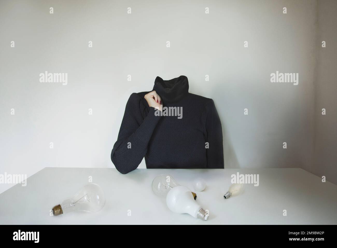headless surreal person looks for the right light bulb for the most ...