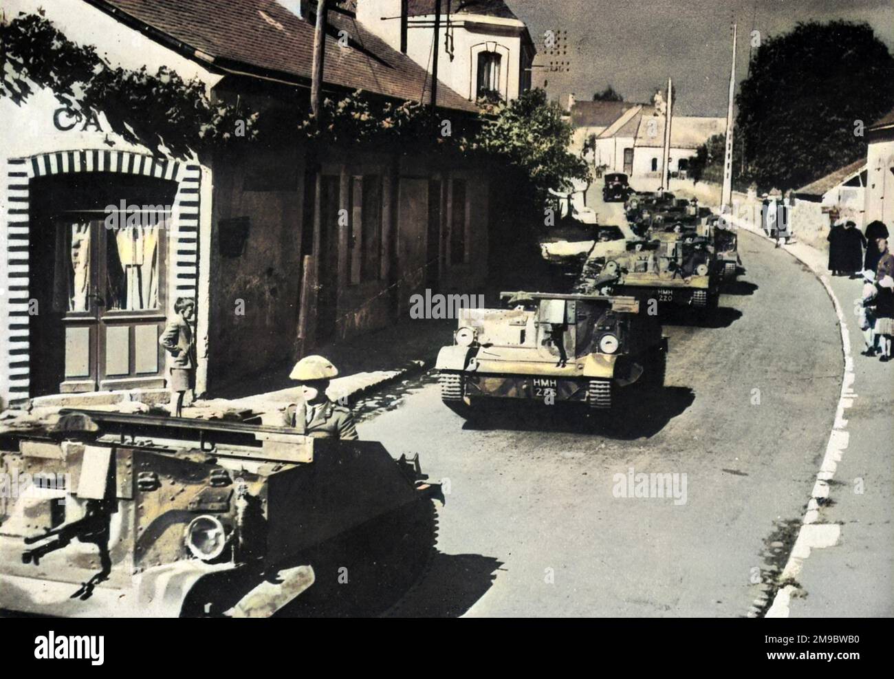 British Bren Machine-Gun Carriers passing through a French village on ...