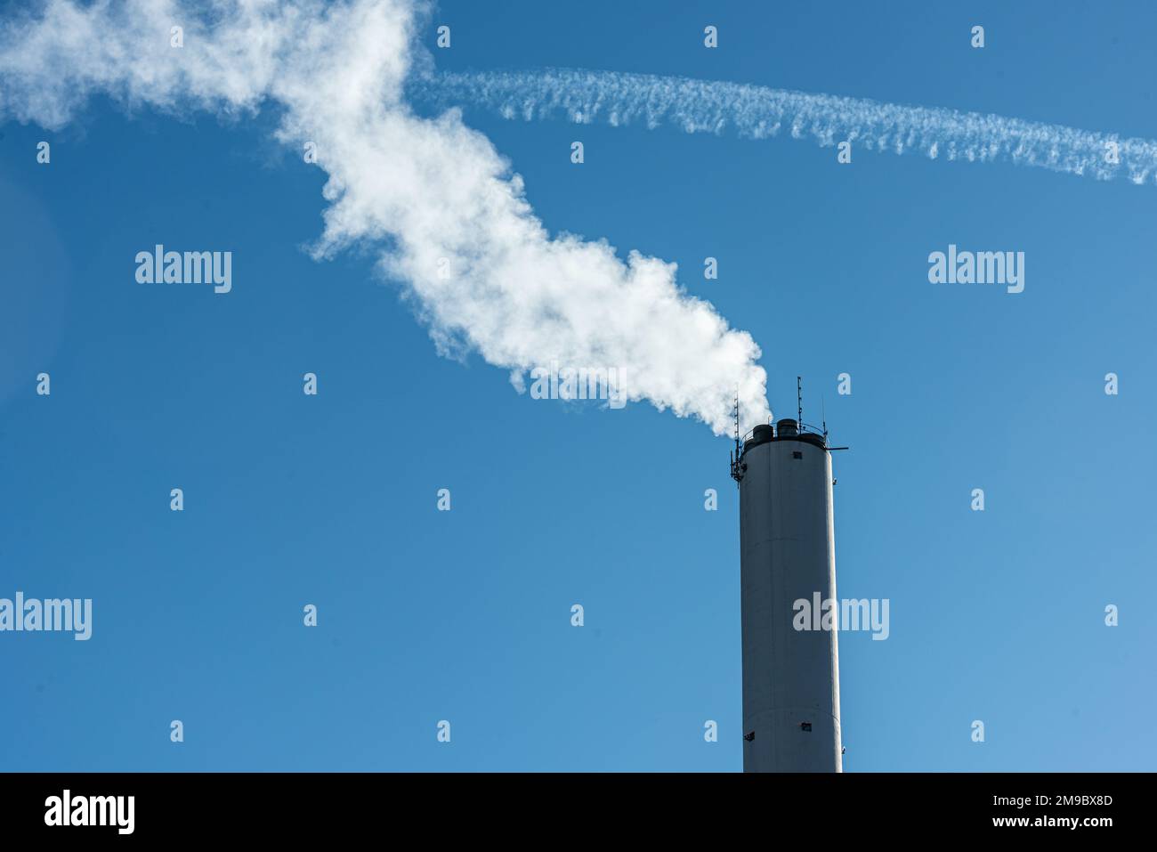 Steam rising from a tall chimney Stock Photo - Alamy