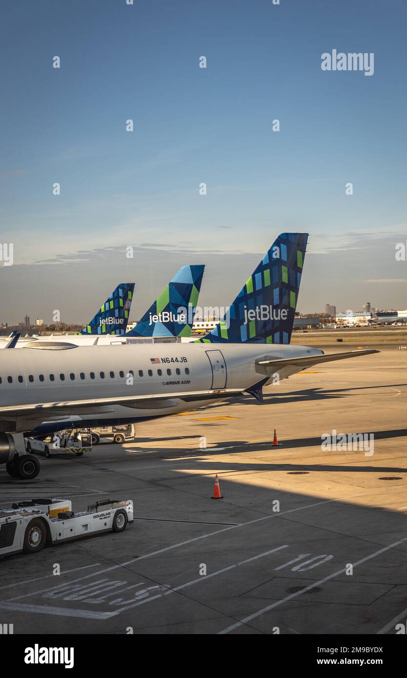 A vertical shot of Jetblue airways planes in a row at John F Kennedy ...