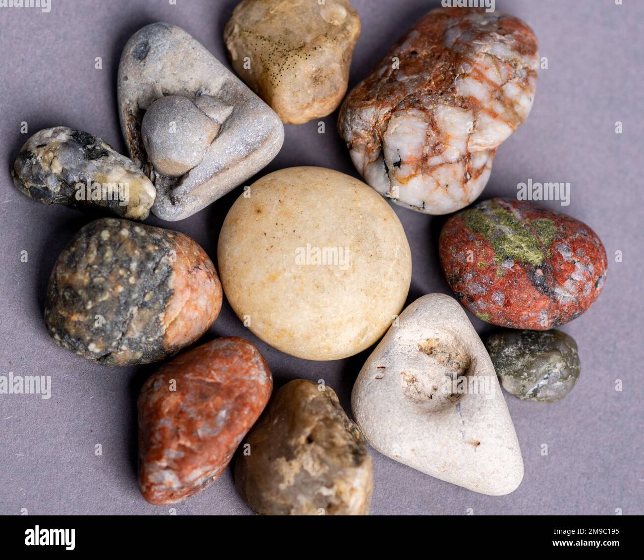 A top view of the colorful natural stones, set in a flower shape, on a ...