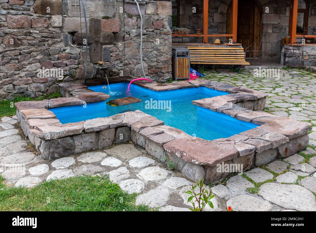 Cross-shaped stone pool with turquoise clear water in Zarzma Monastery ...