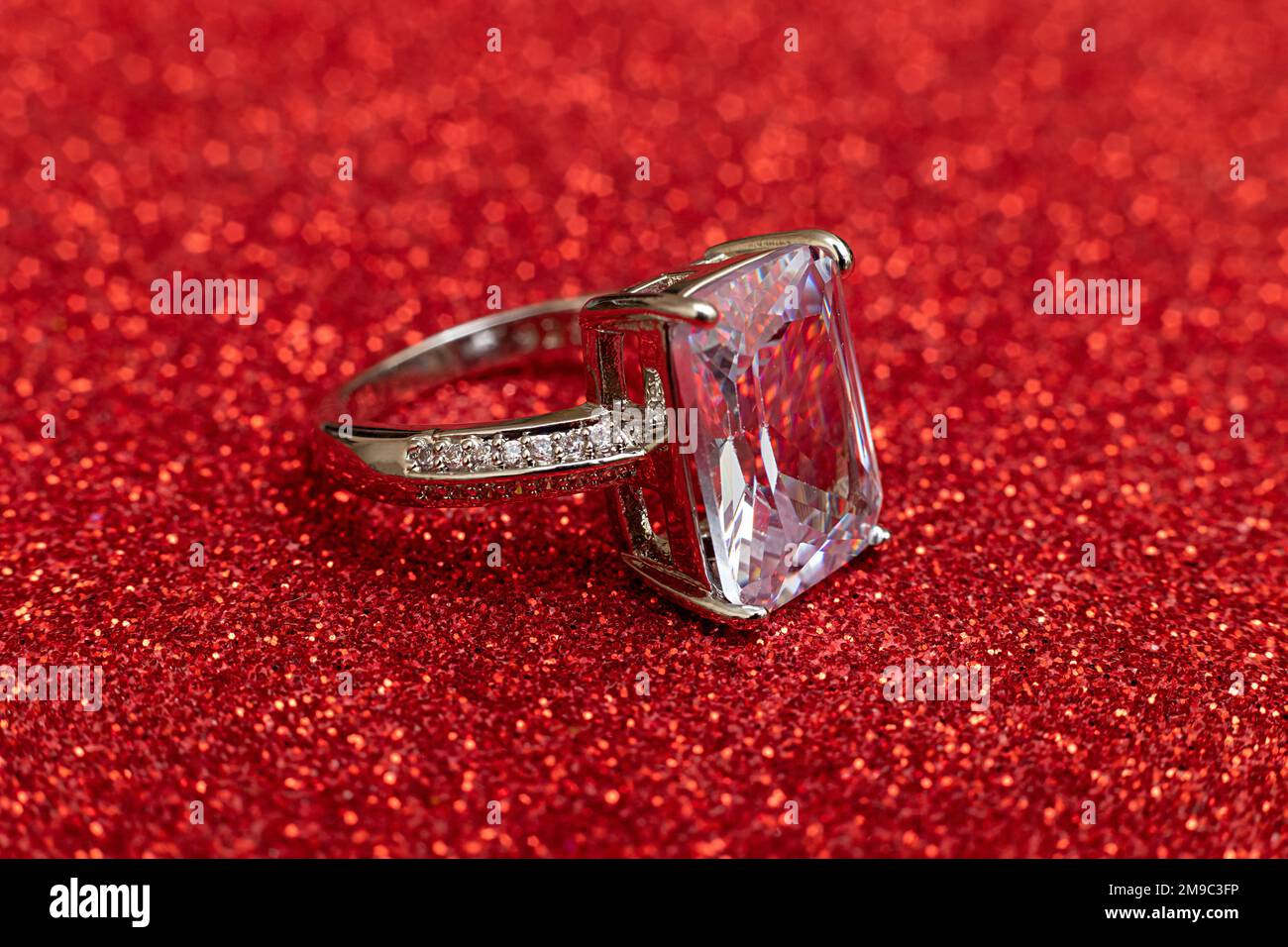 Will you marry me. Wedding ring on red glitter background. Engagement ...