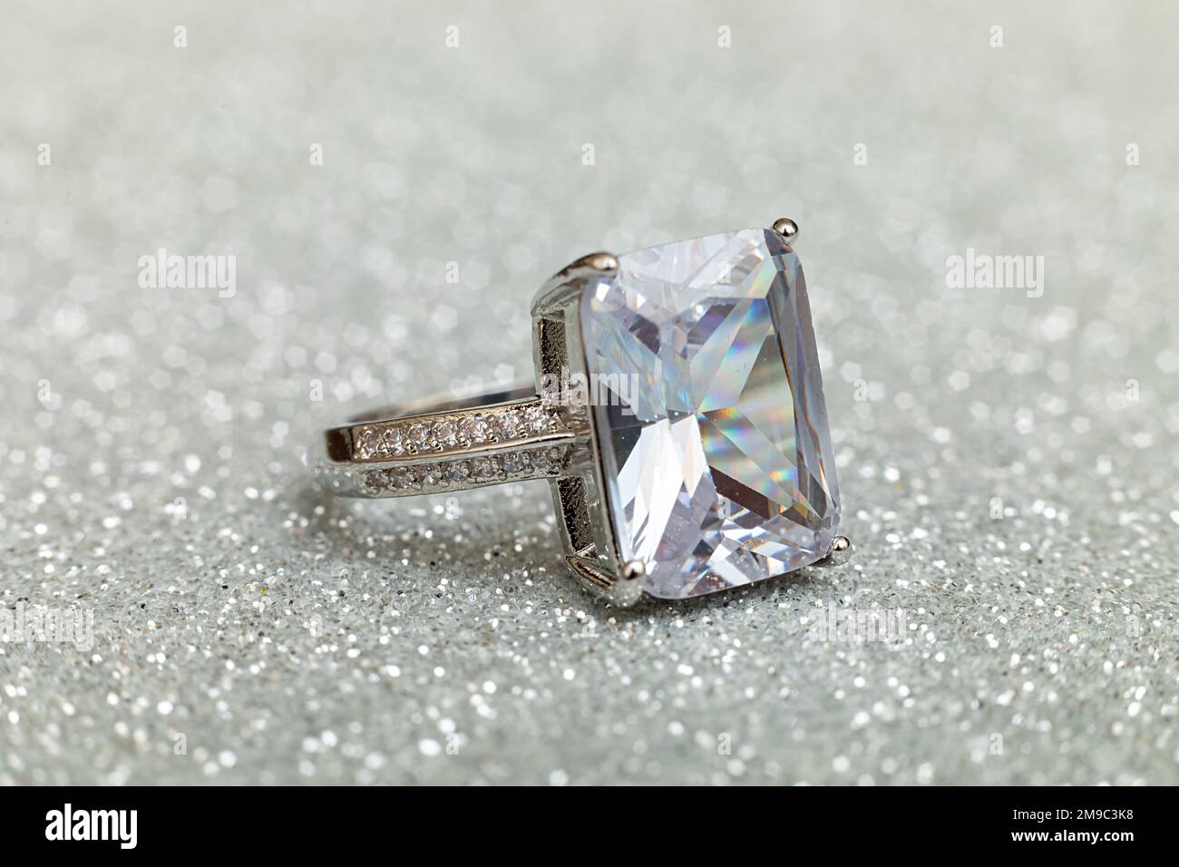 Will you marry me. Wedding ring on silver glitter background ...