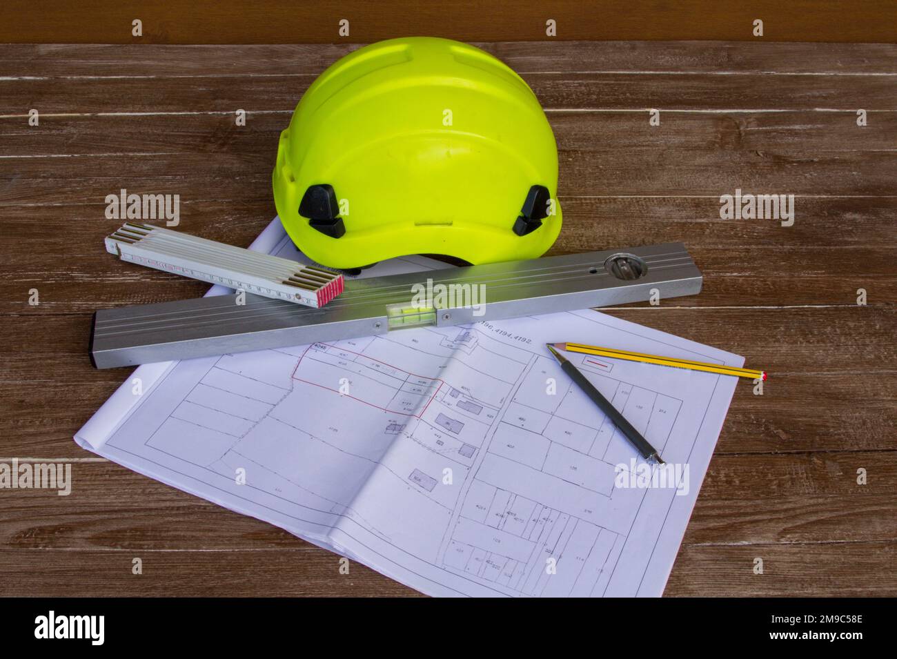 Image of a work table where plans for a building site are placed, a ...