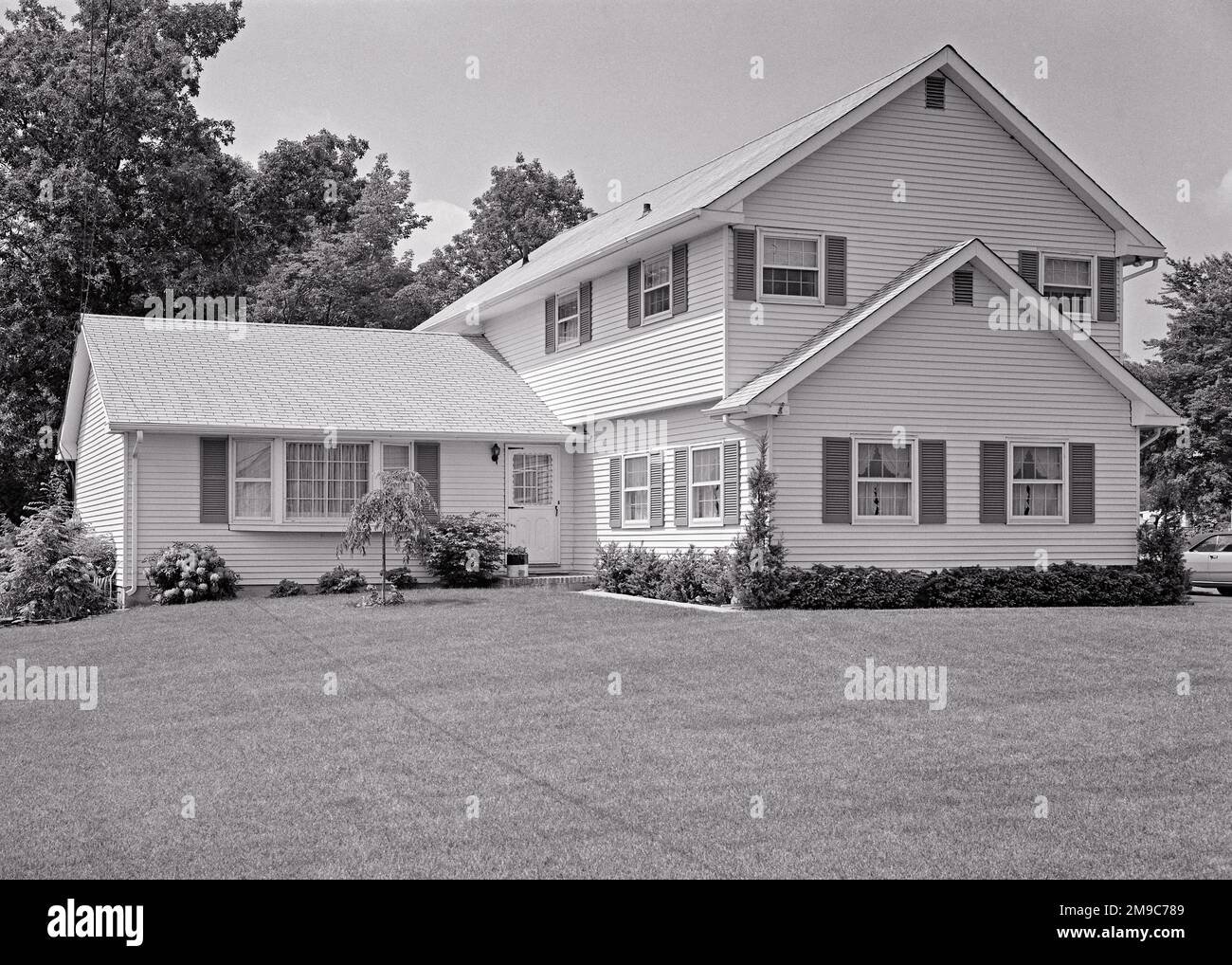 1970s TWO-STORY FRAME SUBURBAN HOME WITH SHUTTERS BAY WINDOW FRONT LAWN ...