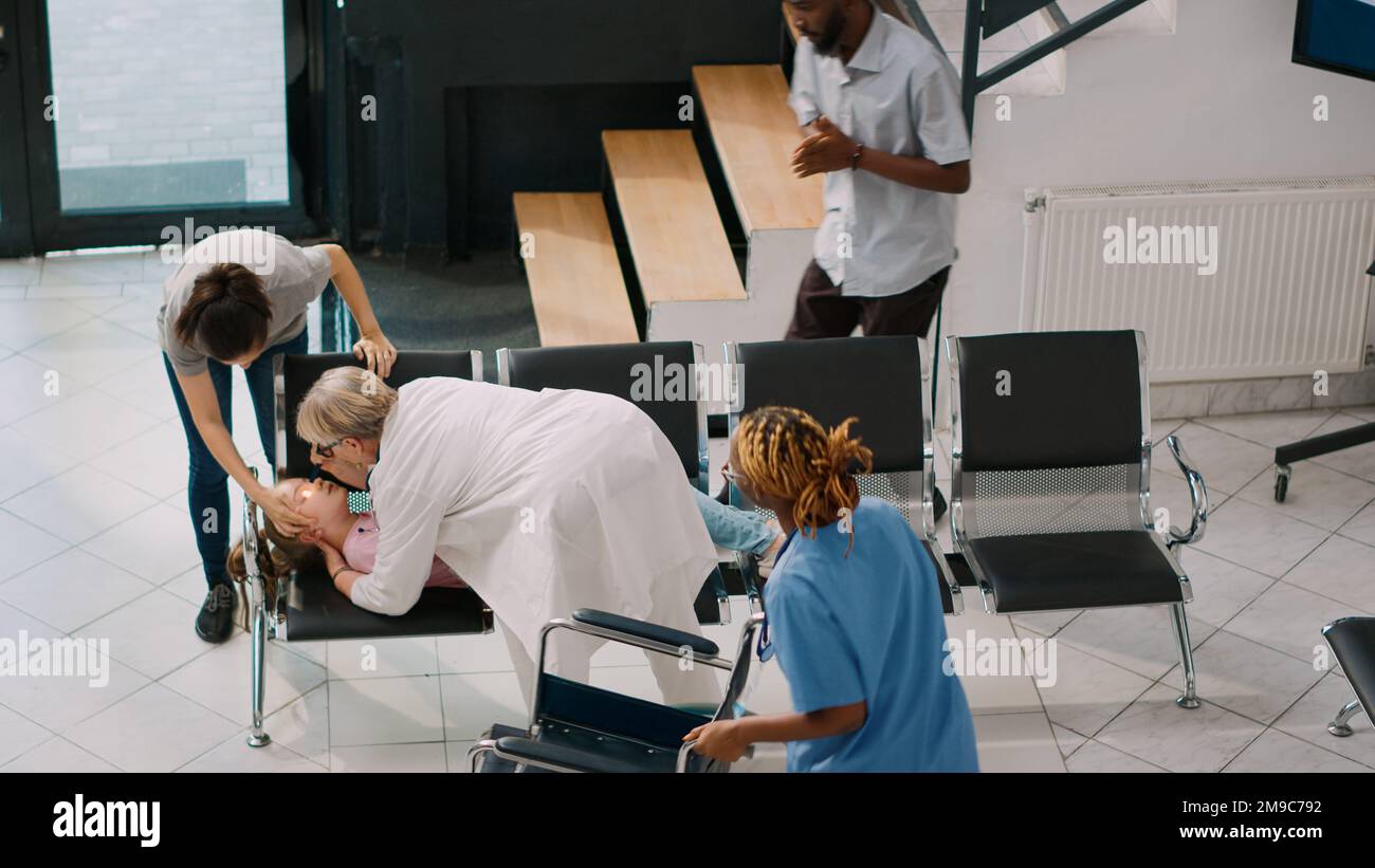 Worried father carrying unconscious child in hospital lobby, kid ... Worried father carrying unconscious child in hospital lobby, kid ...