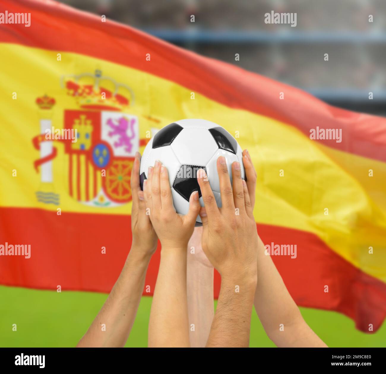 Group of football players holding a soccer ball at football stadium ...