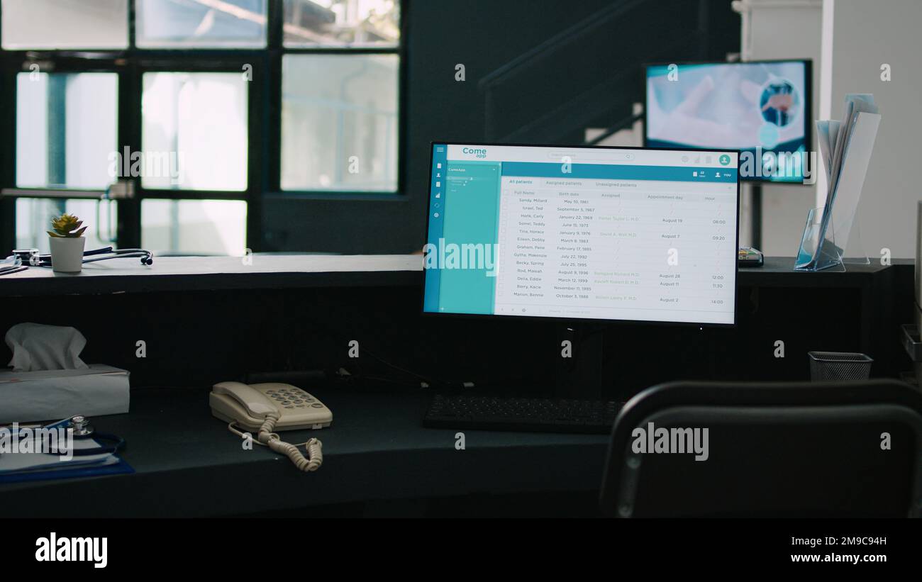 Hospital reception counter with computer showing appointments list ...