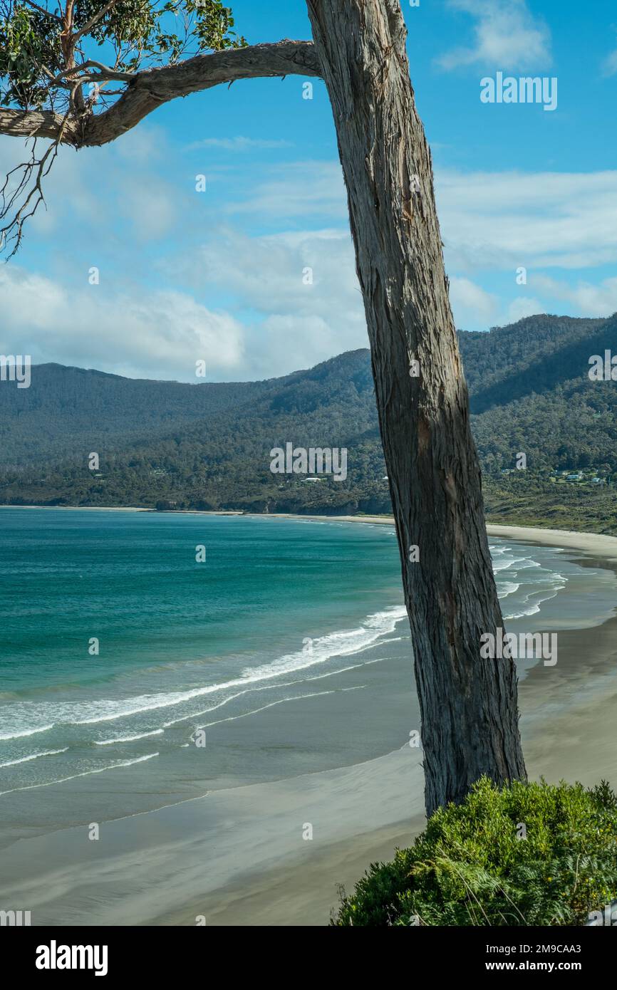 A beautiful bay with white sand aqua coloured water and mountains Stock ...