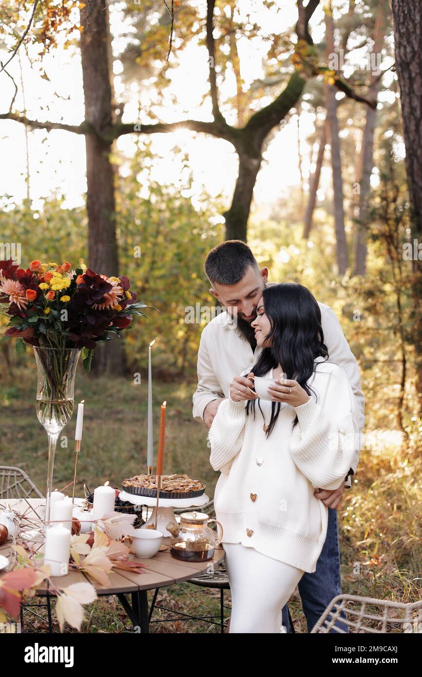 Valentines day. Young romantic couple is having picnic, hugging and ...