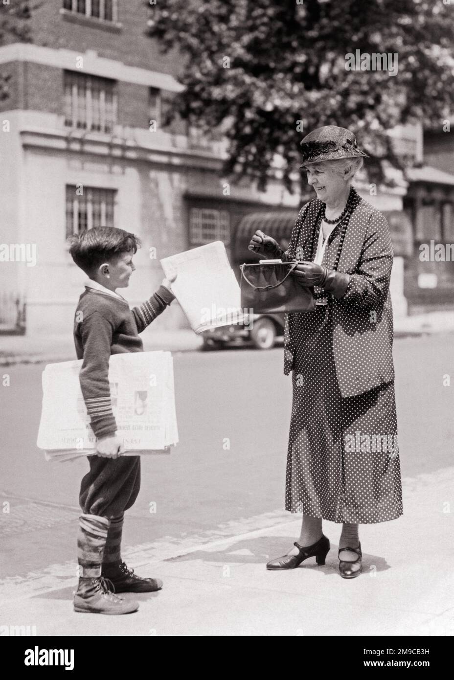 1930s YOUNG NEWSPAPER BOY IN KNEE BRITCHES ON STREET CORNER SELLING ...
