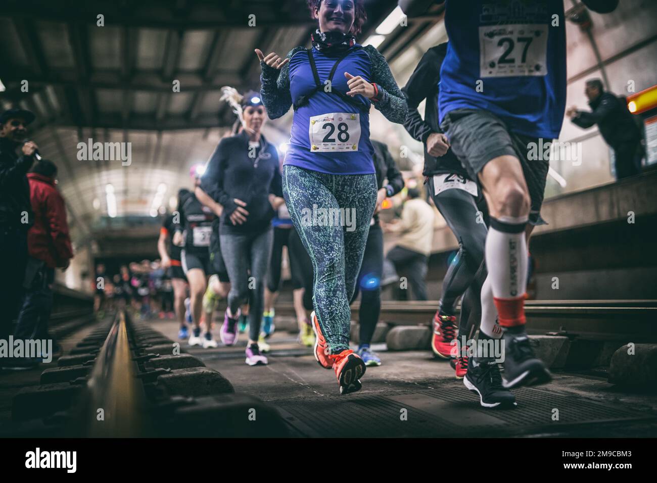 Runners running in a race in the Bilbao subway Stock Photo - Alamy