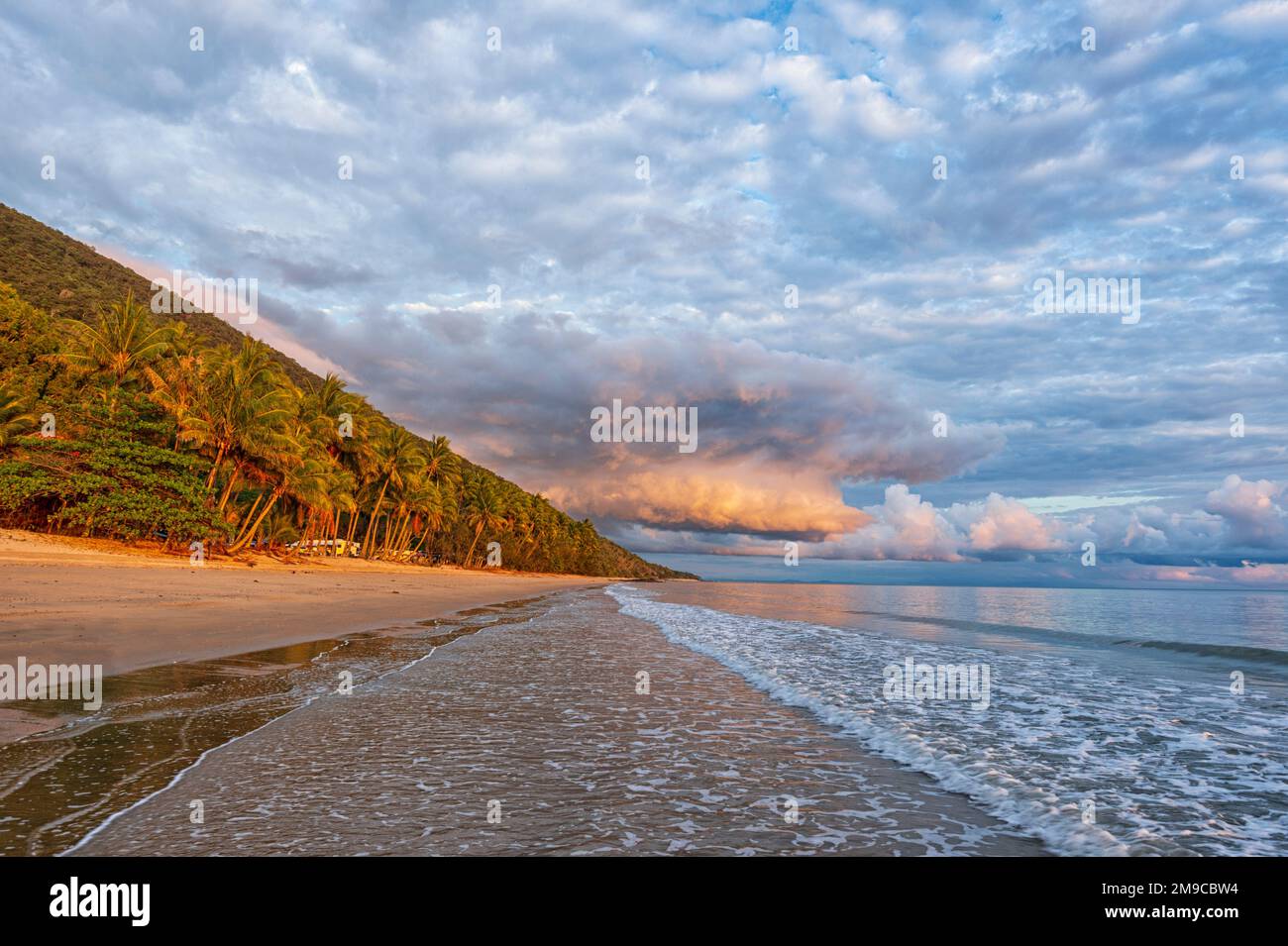 Scenic view of Ellis Beach at sunrise with pink cloud formations ...
