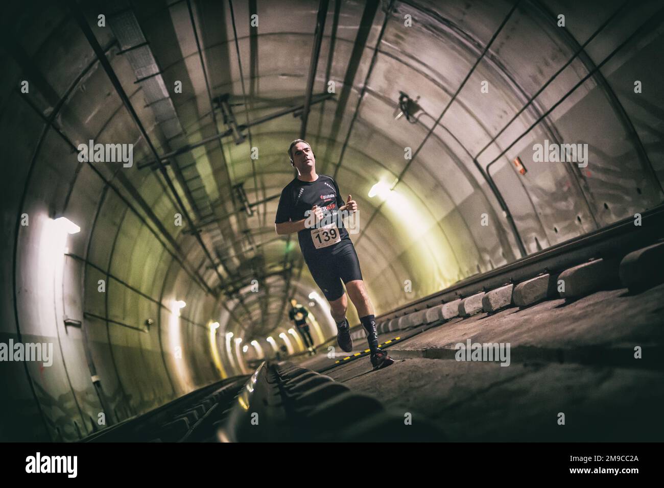 Runner running in a race in the Bilbao subway Stock Photo - Alamy
