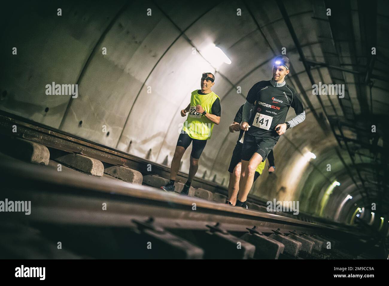 Runners running in a race in the Bilbao subway Stock Photo - Alamy