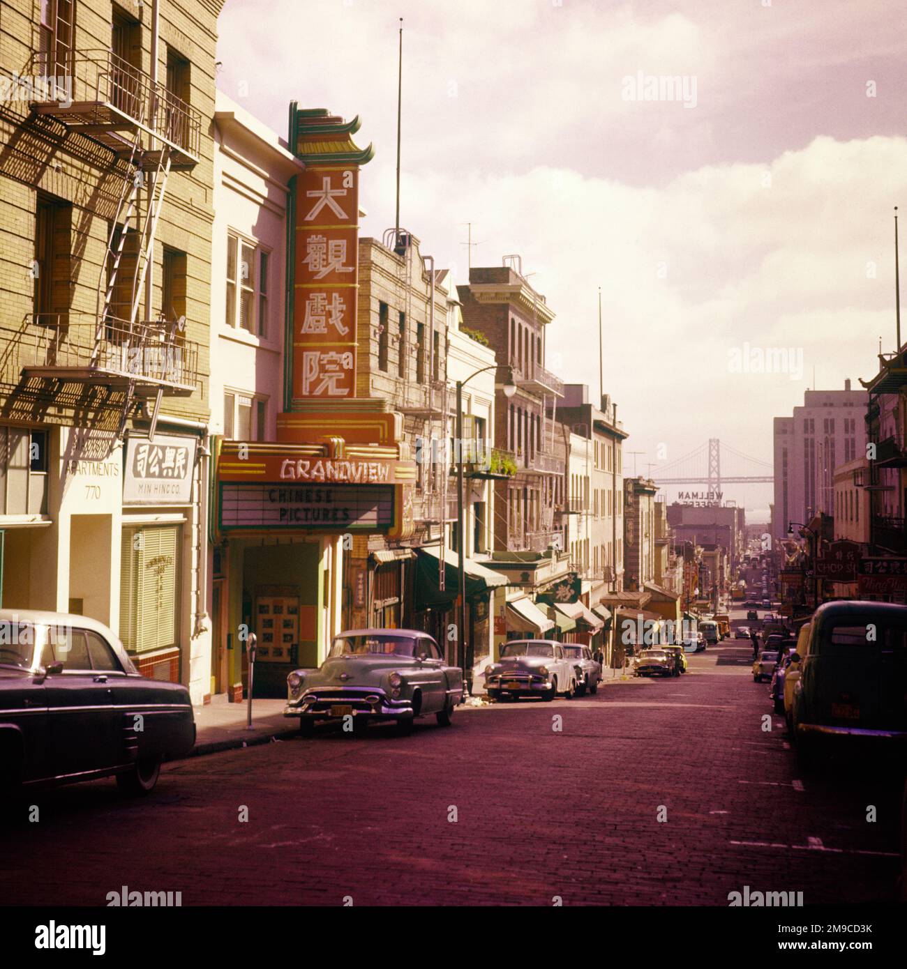 1950s SAN FRANCISCO CHINATOWN STREET WITH OAKLAND BAY BRIDGE IN ...