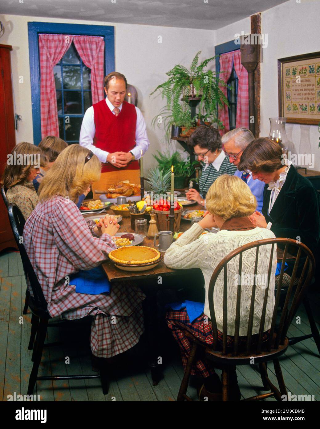 1970s THREE GENERATION FAMILY AT DINING TABLE PRAYING SAYING GRACE ...
