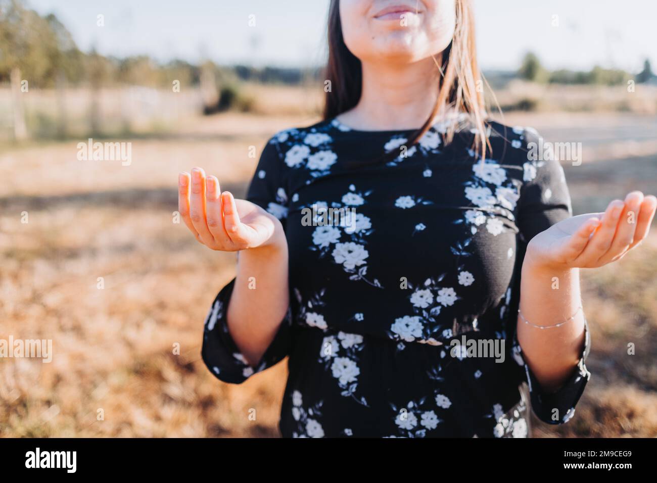 Religious believer woman praying, raising hands to to receive God's ...