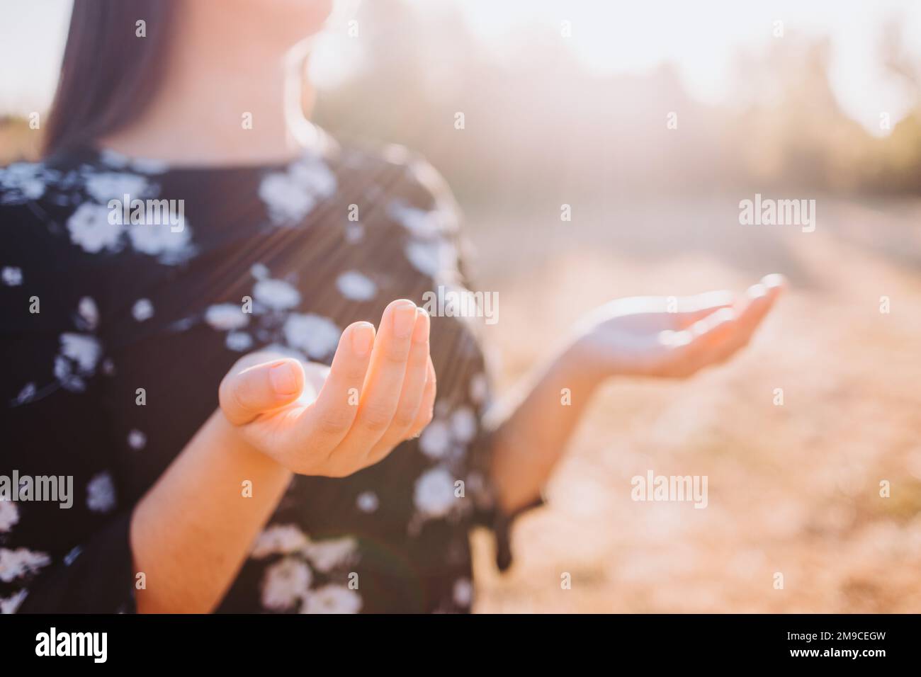 Religious believer woman praying, raising hands to to receive God's ...