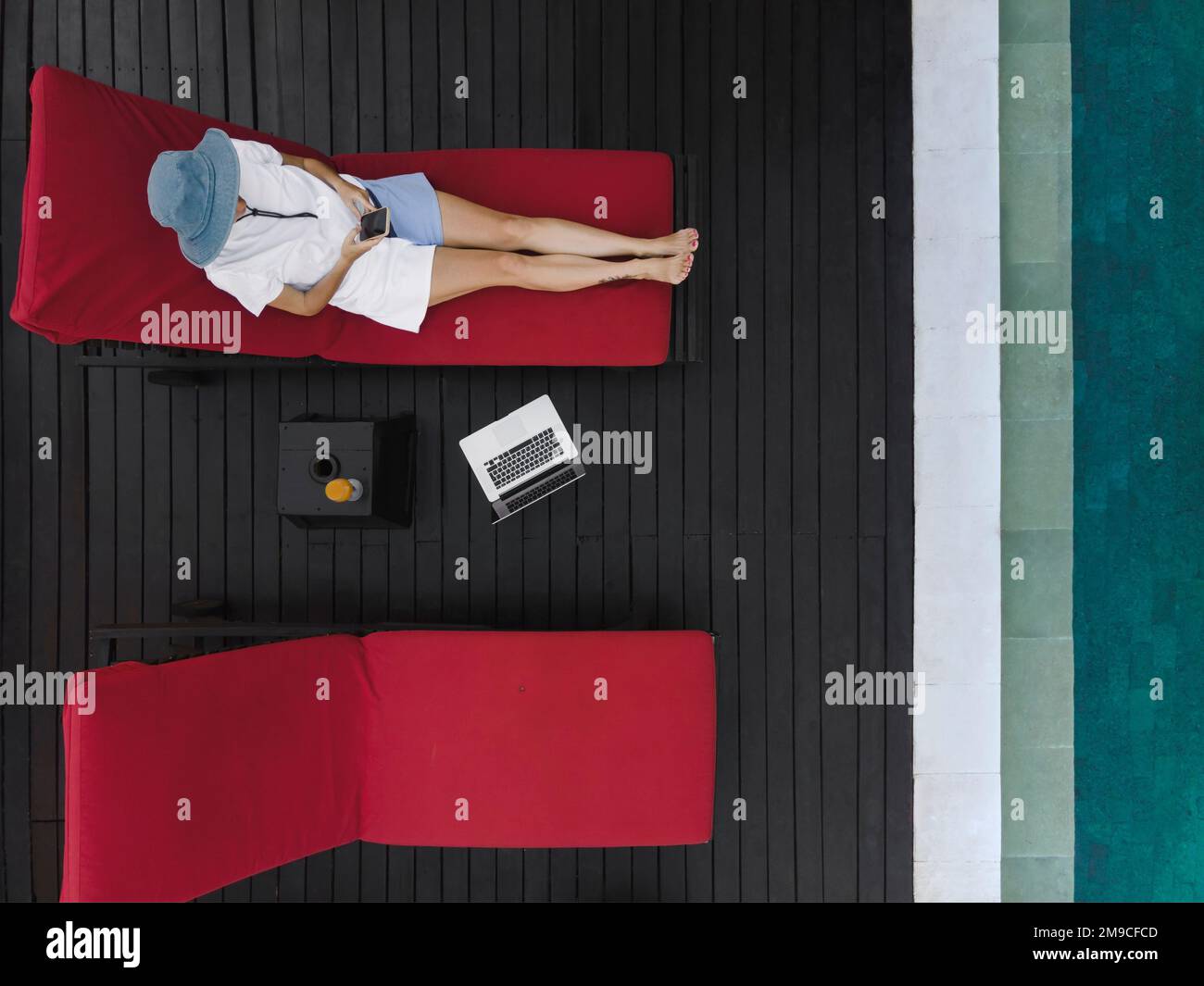 Aerial view young woman with laptop near pool Stock Photo - Alamy