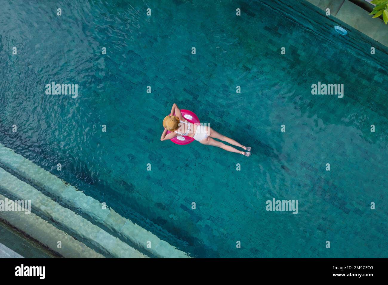 Rear view young woman swimming pool hi-res stock photography and images ...