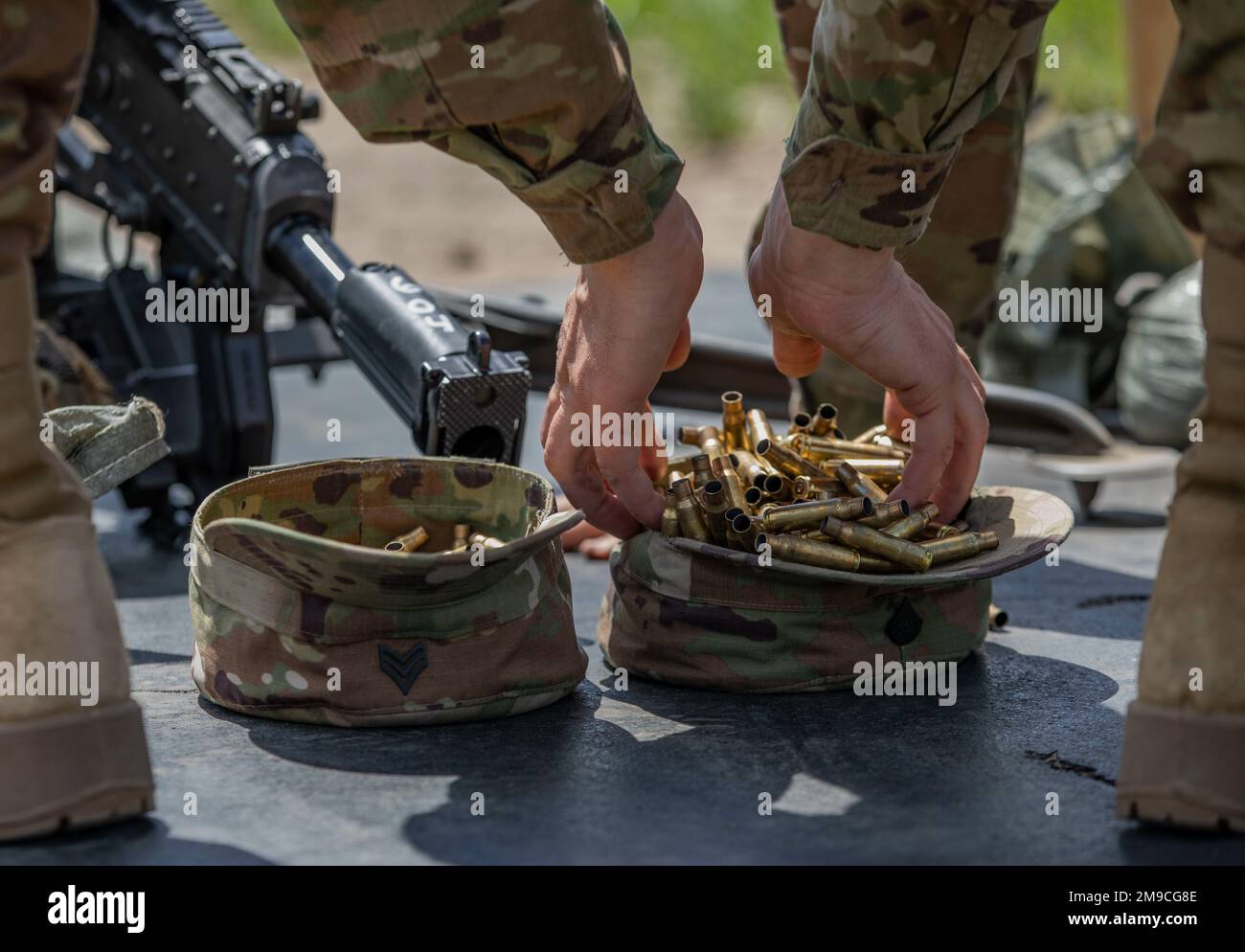An Army Reserve Soldier uses the Army Patrol Cap to collect empty shell ...
