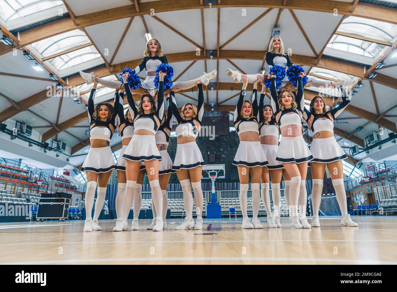 Young smiling cheerleaders posing hi-res stock photography and images ...