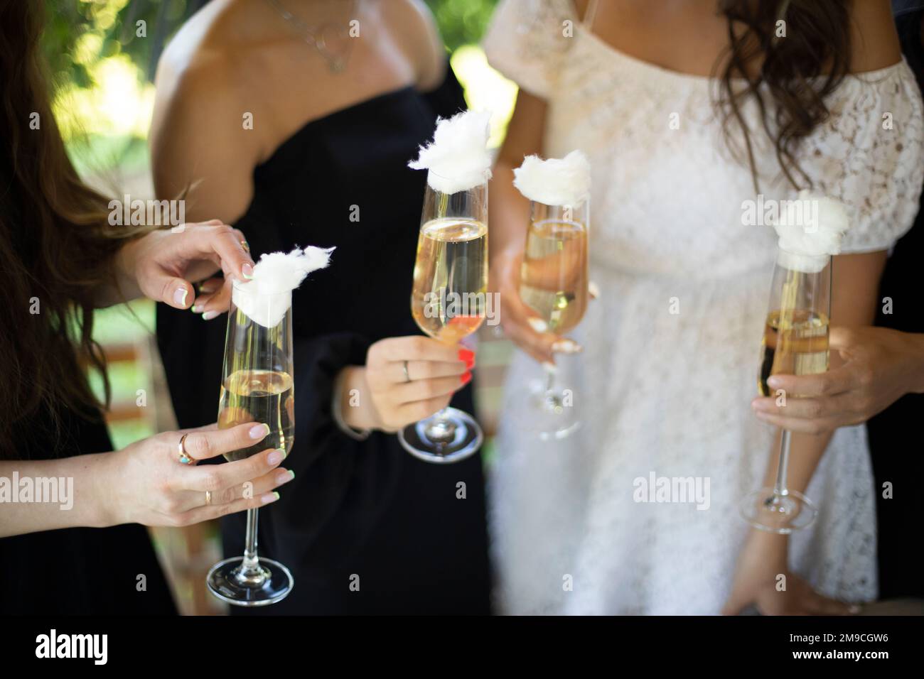 Bride and friends. Alcohol at party. Glasses in hands of girls Stock ...