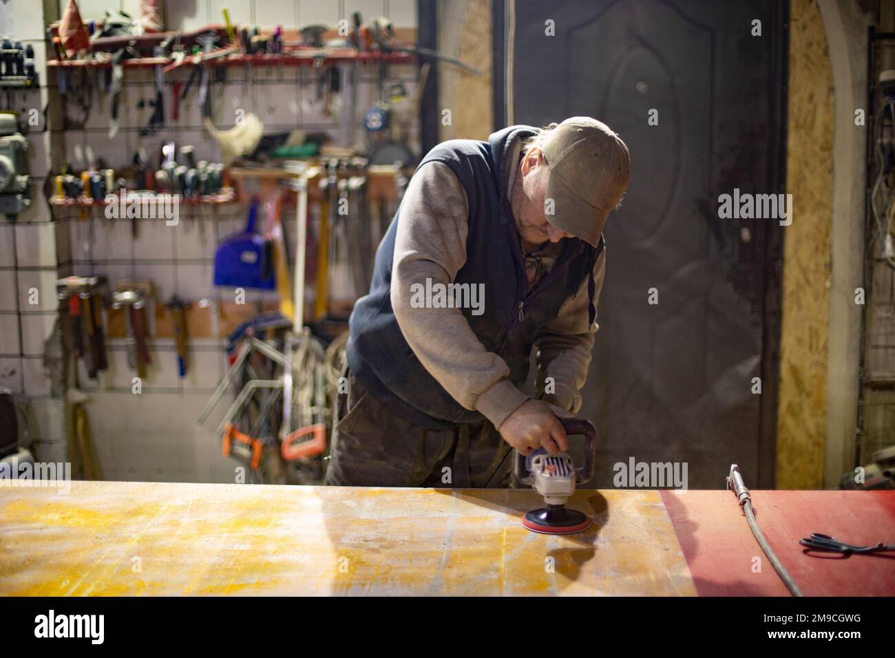Male artisan grinds wooden board hi-res stock photography and images ...