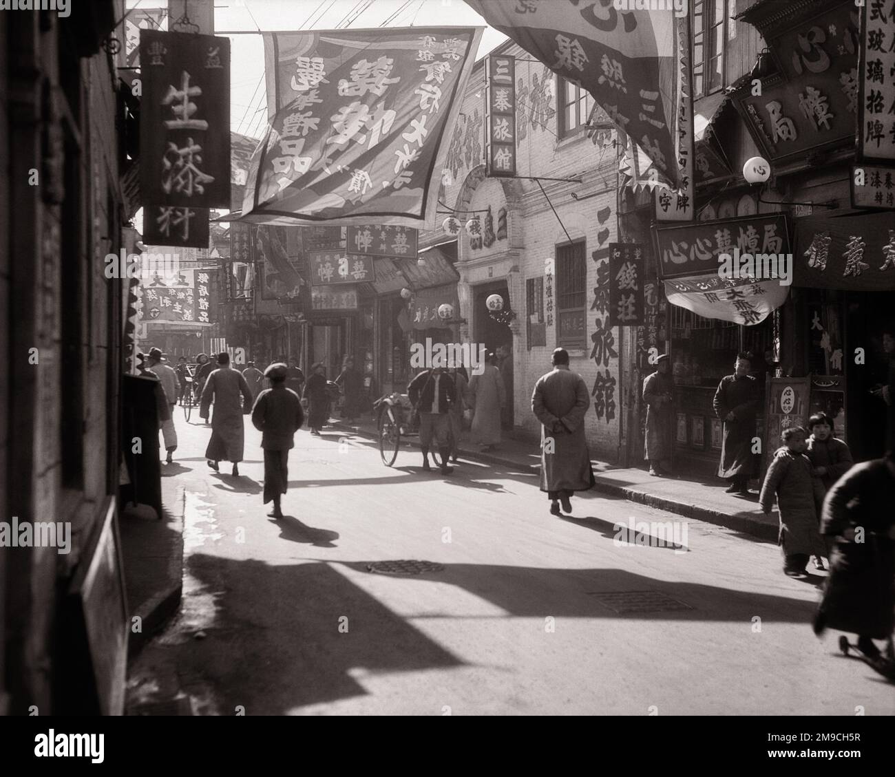 1920s 1930s CITY OF FORTUNE LATE AFTERNOON SUN SILHOUETTED PEDESTRIANS ...