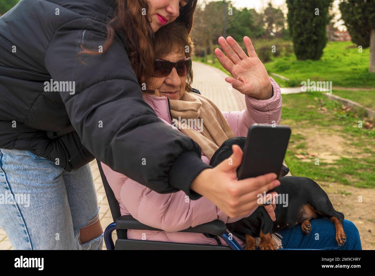 a girl taking photos with her grandmother in a wheelchair Stock Photo ...