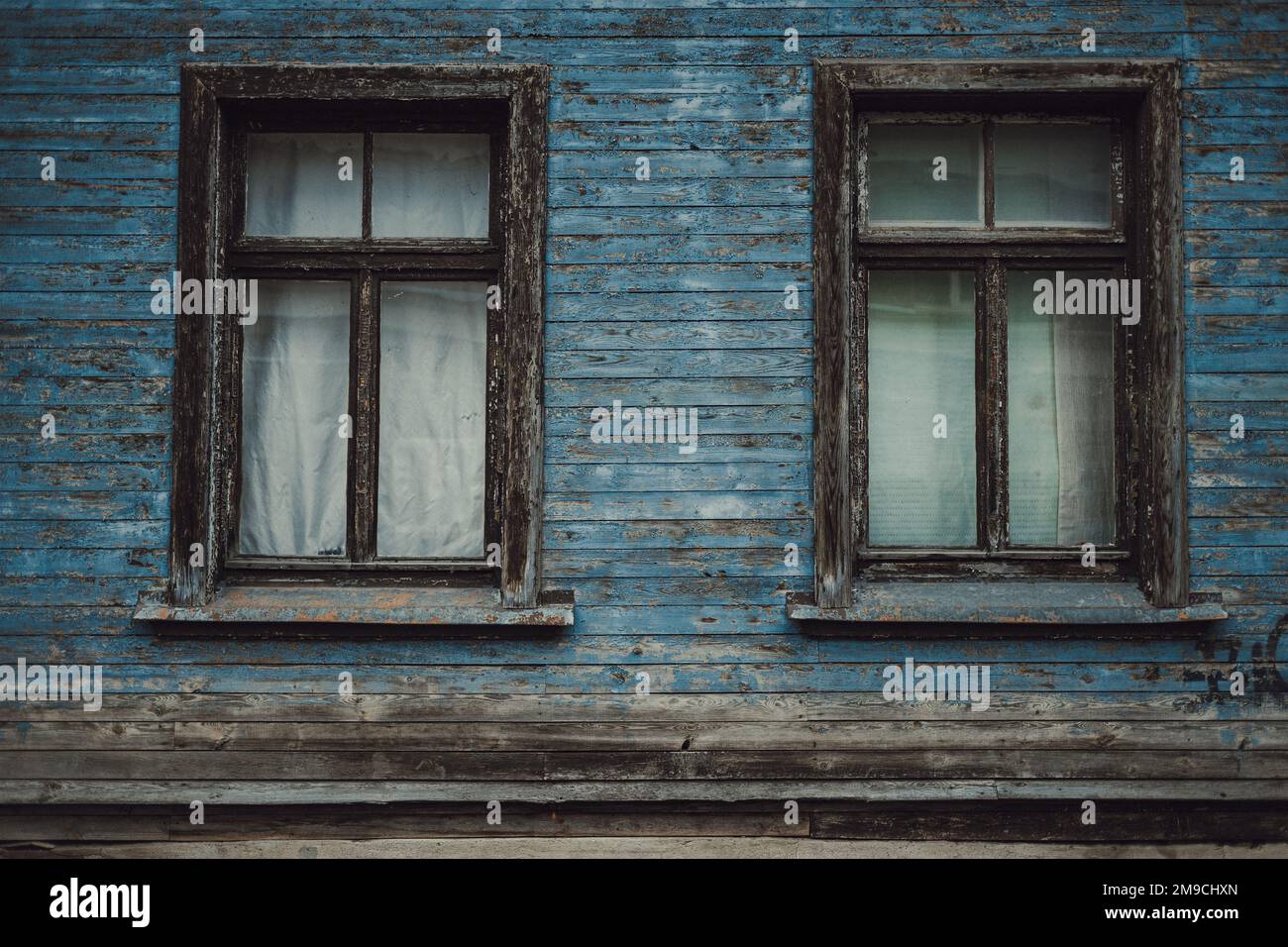 An old wooden house with closed glass windows Stock Photo - Alamy