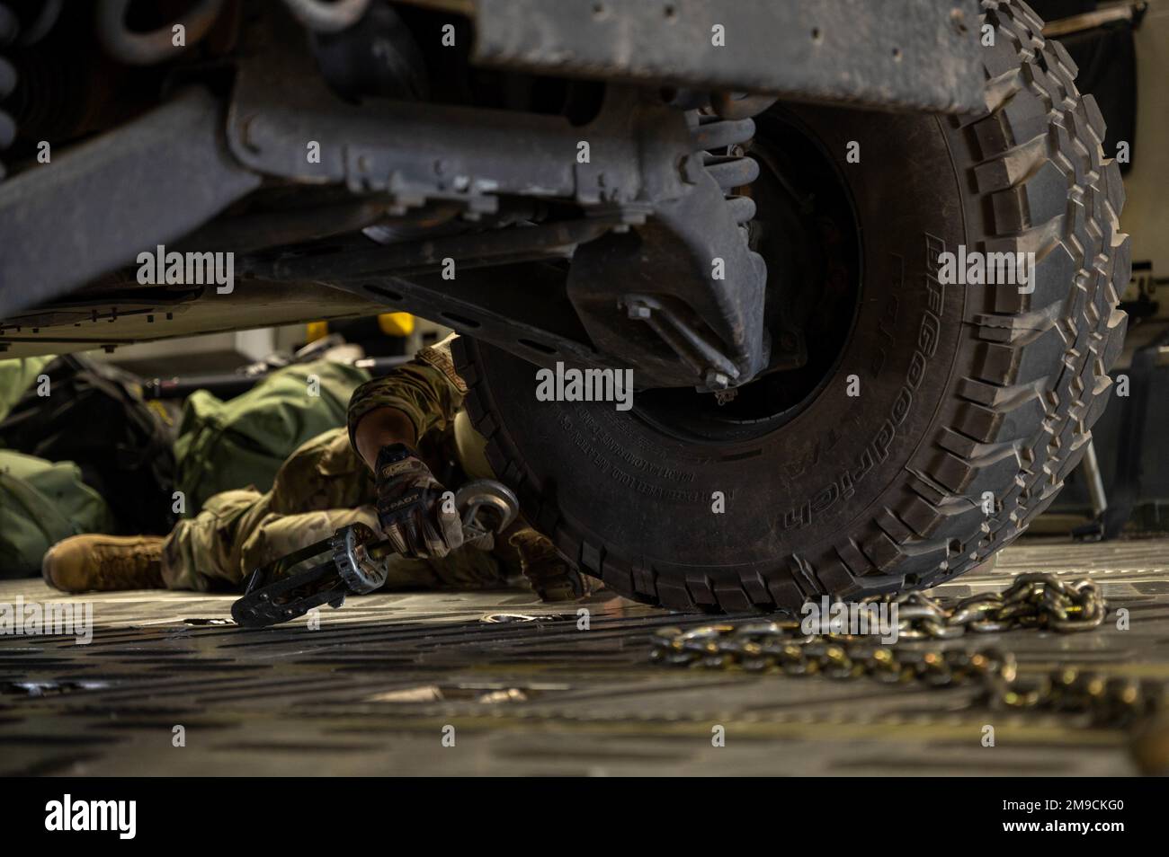 U.S. Airmen secure a High Multipurpose Mobility Wheeled Vehicle on a C ...