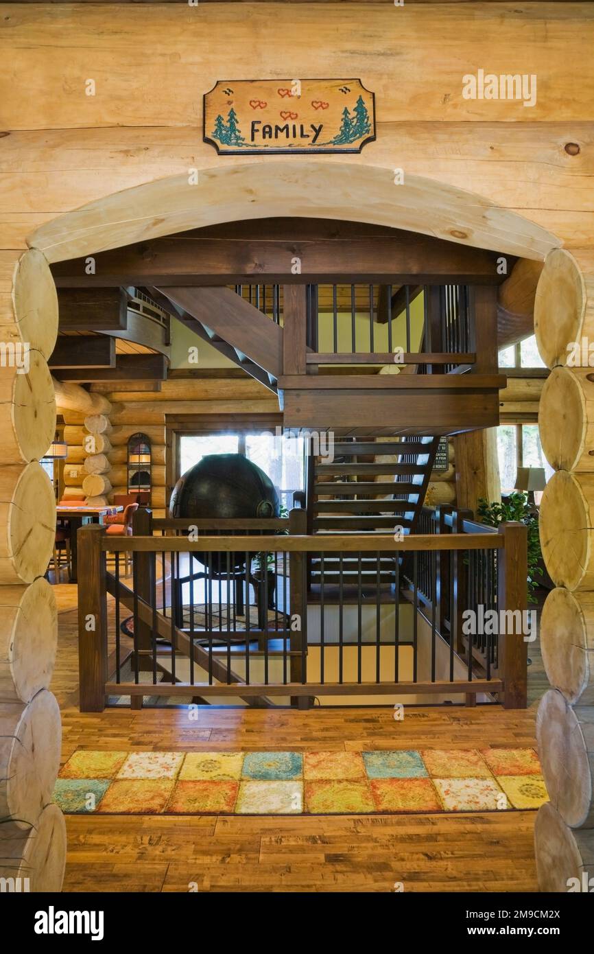Wooden arch in main entrance hall, colourful runner and brown stained ...