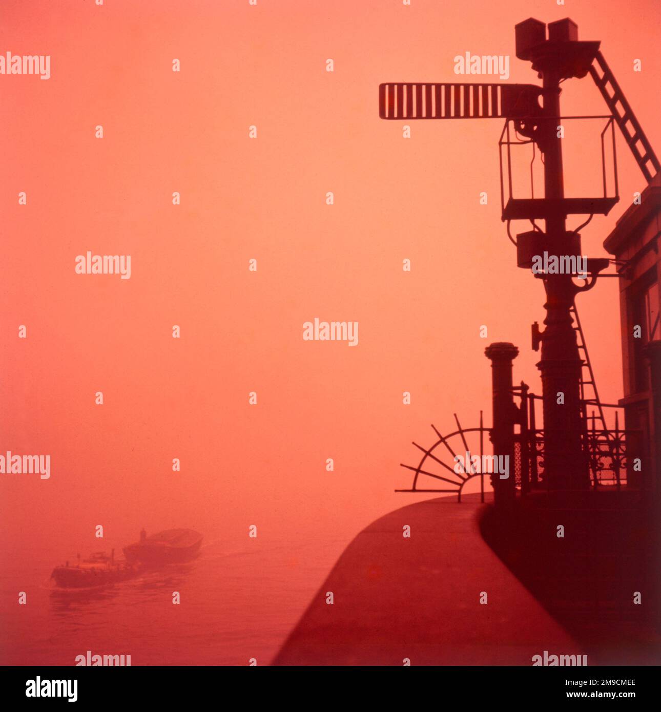 A thick London smog masks everything, apart from a signal box on a tow ...