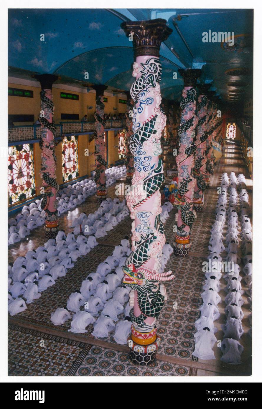 Caodaist worshippers praying in their temple; note: the ornate ...