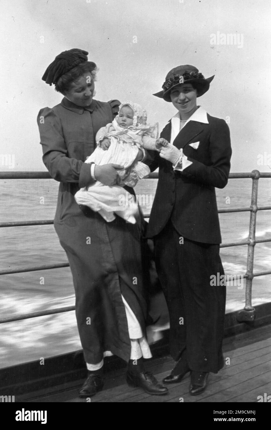 A mother and her baby with their Nanny on the deck of a ship Stock ...