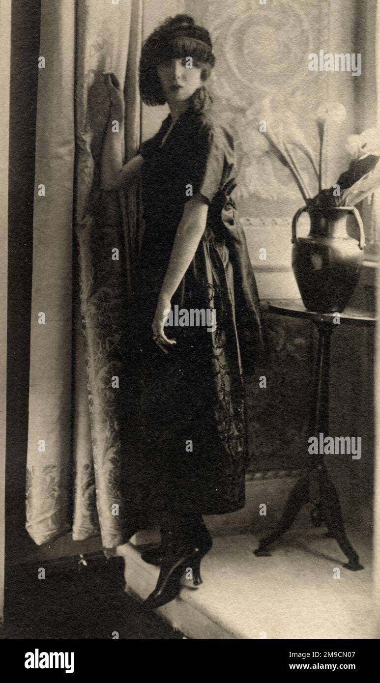 Photograph of a beautiful, if haughty, looking woman posed by a window ...