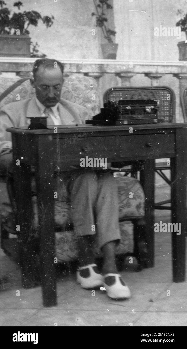 A smart gentleman sitting at his writing desk in the open air Stock ...