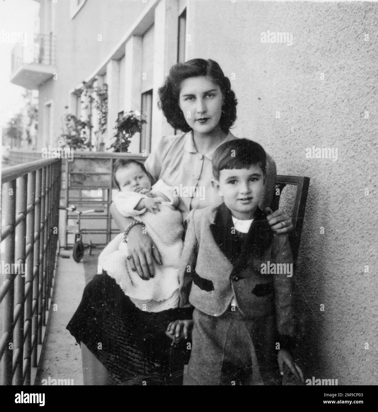 A young mother, her son, and baby daughter, on a balcony in Rome Stock ...