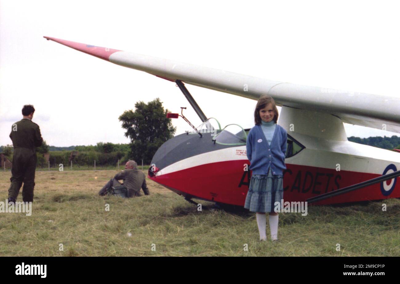 A little girl stands in front of a plane at the Kenley Air Show in ...