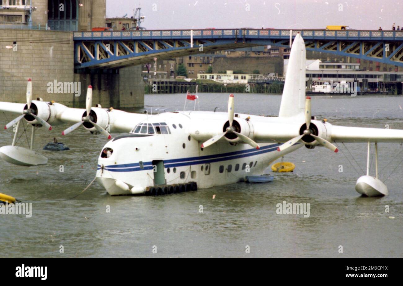 A flying boat with four propellers rests on the River Thames in Central ...