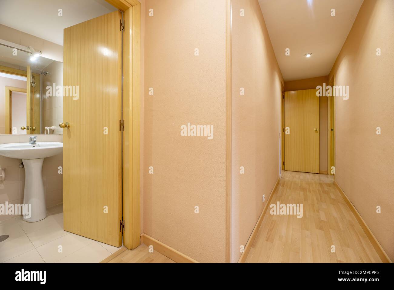 corridor of a residential house with oak doors leading to other rooms ...
